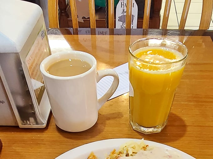 Coffee in a sturdy mug and orange juice so bright it could wake you up before you even take a sip – breakfast beverages done right.