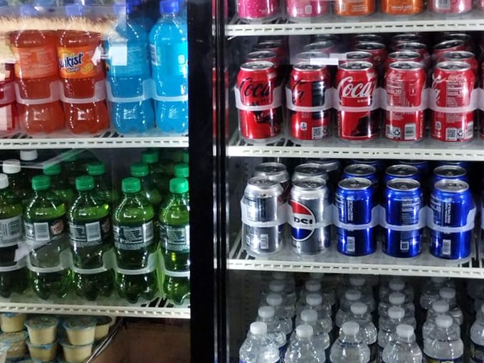 The drink cooler stands ready with the perfect companions to cut through all that delicious fried goodness—liquid reinforcements for the flavor battle ahead.
