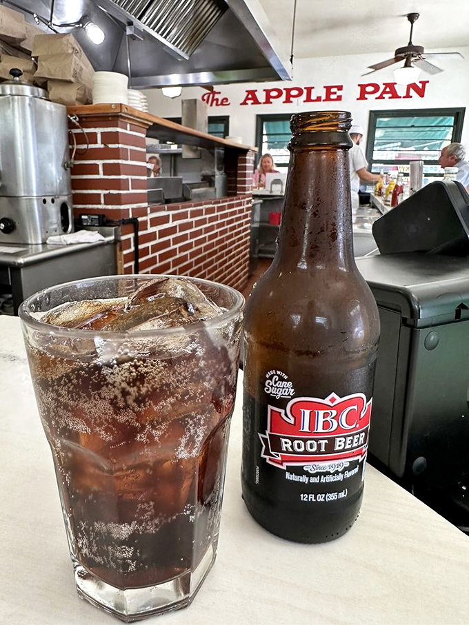That IBC root beer hits differently at The Apple Pan – maybe it's the classic bottle, maybe it's the surroundings, or maybe some pleasures really are timeless.