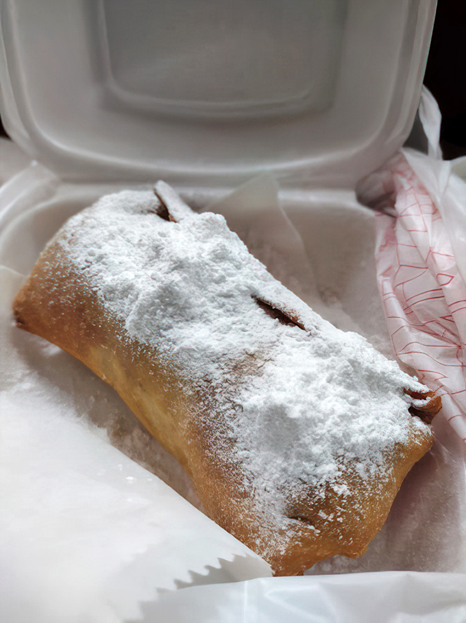 This isn't just dessert—it's a fried peach pie dusted with powdered sugar that would make your grandmother simultaneously proud and jealous.