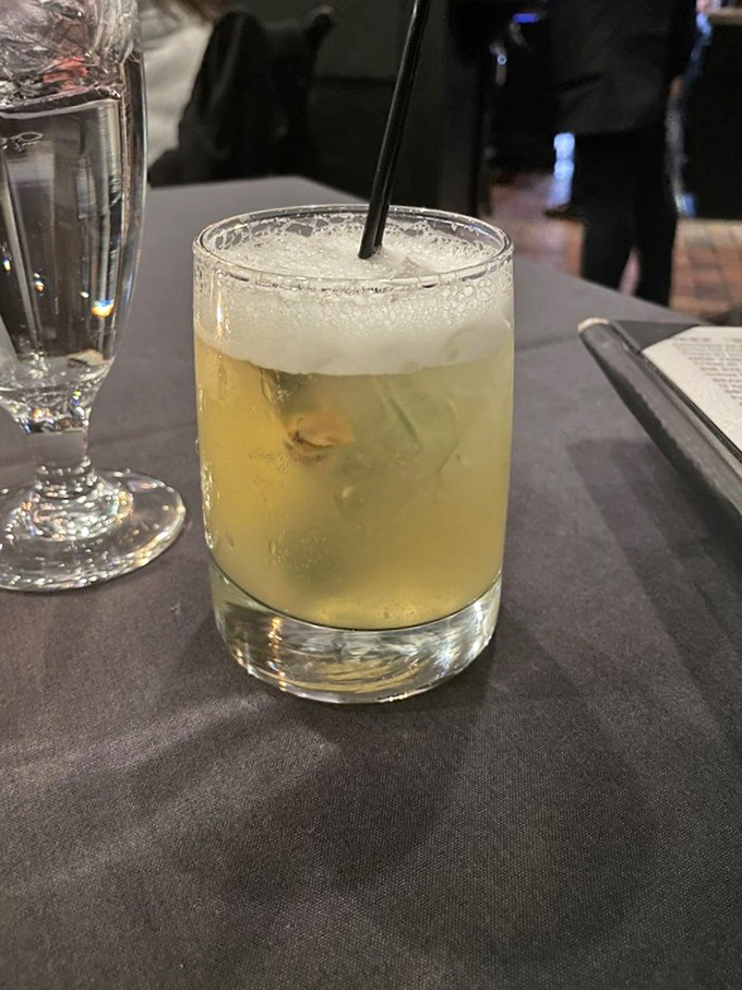 A properly crafted cocktail is liquid architecture. This golden elixir with its perfect foam cap proves Bridget's bartenders are master builders.