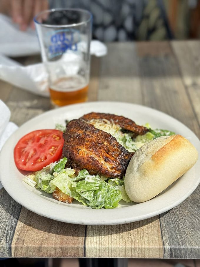 Blackened grouper resting on a Caesar salad isn't just lunch—it's a flavor intervention. That perfectly charred crust is where the magic happens.