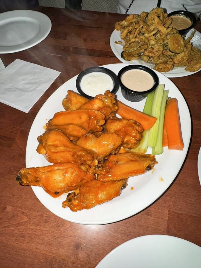 Buffalo wings with attitude, served with the vegetable sticks we all pretend make this a balanced meal. Napkins required, regrets impossible.