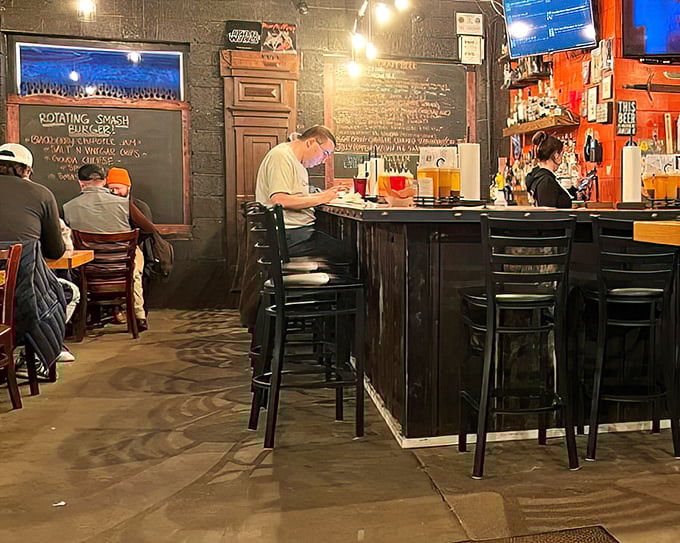 The bar area—where barbecue pilgrims gather to worship at the altar of smoke and sauce, beneath the glow of TVs and good vibes.