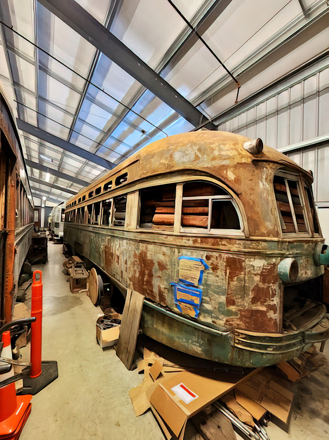 A trolley restoration project in progress – this sleeping beauty awaits its transformation from rusted relic to gleaming museum star. Every peeling paint patch tells a story.