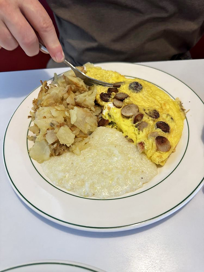 This omelet has more fillings than your average novel has plot twists, paired with hash browns that crackle with each forkful.