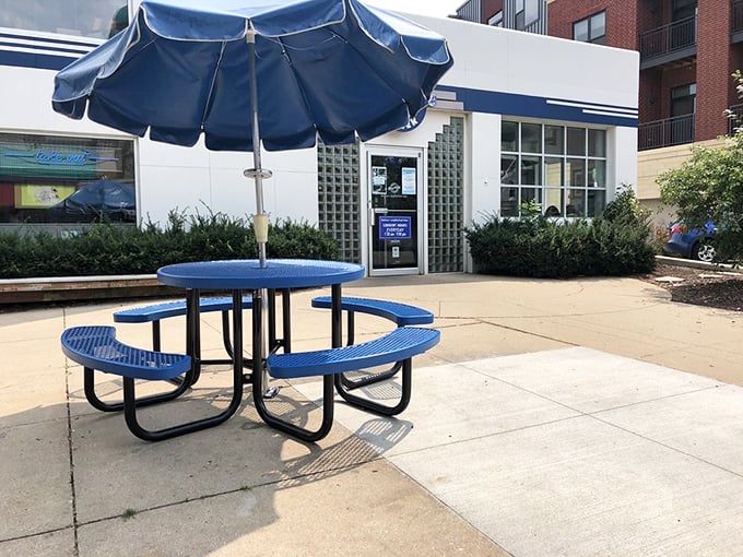 The diner's cheerful exterior promises good things inside. That blue umbrella has sheltered many waiting patrons dreaming of pancakes.