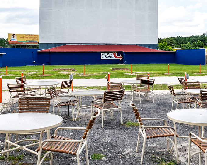 These outdoor tables facing the massive screen offer the best of both worlds—the comfort of restaurant seating with the magic of outdoor cinema.