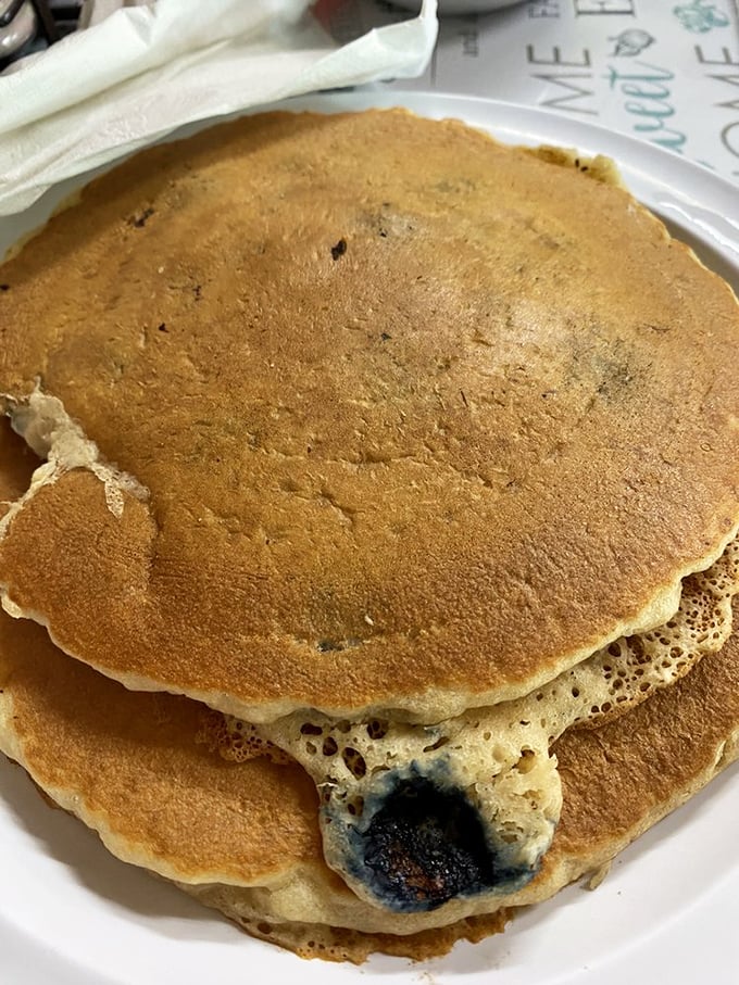 These blueberry pancakes aren't just breakfast, they're an event. Each purple burst is a tiny flavor explosion waiting to happen.