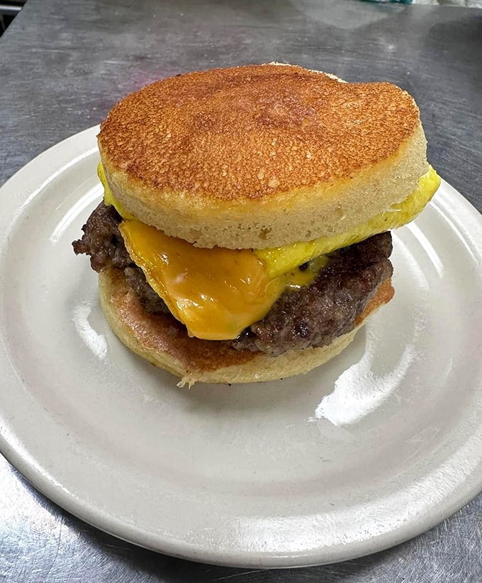The breakfast sandwich that makes you question why we don't use pancakes as bread for everything – pure morning genius on a plate.