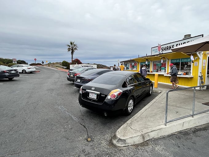 The parking lot dance: where hopeful diners circle like seagulls, eyes locked on patrons wiping the last shake from their lips.