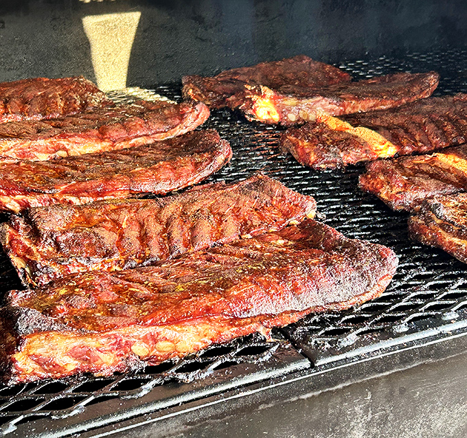 Fresh racks sizzling on the grill, developing that beautiful bark that makes barbecue enthusiasts shed happy tears.
