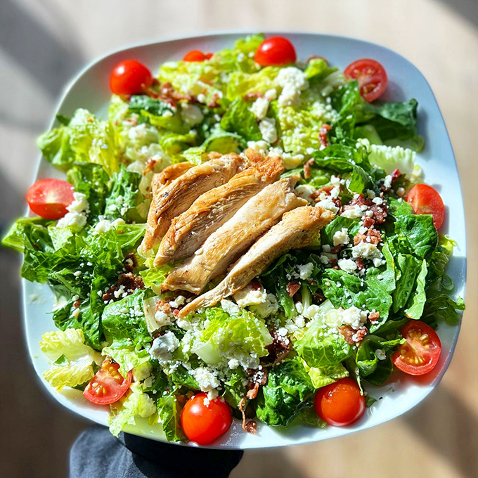 A salad that doesn't feel like punishment. Fresh greens, juicy tomatoes, and perfectly grilled chicken prove healthy eating doesn't require sacrifice.
