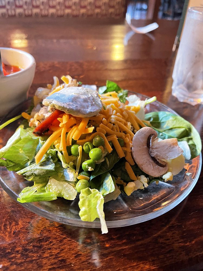 Even the salad deserves attention—a colorful prelude to the main event that somehow makes eating vegetables feel like an indulgence rather than a obligation.