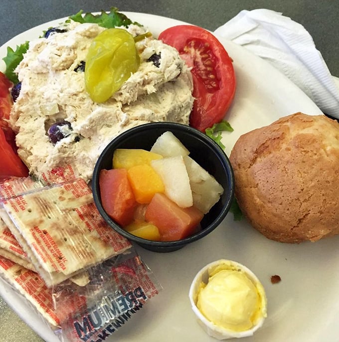 A chicken salad plate that proves healthy-ish options don't have to be punishment. That muffin isn't just a side—it's dessert in disguise. 