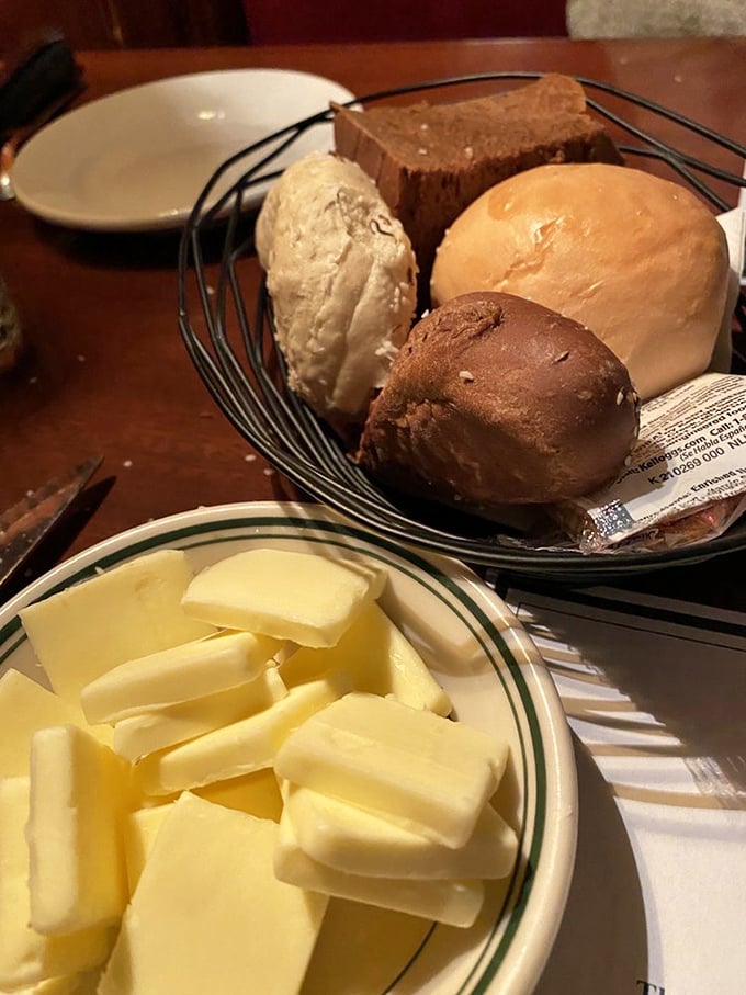 The bread basket arrives like a warm handshake—fresh rolls and those addictive salt sticks that somehow disappear before the appetizers arrive.