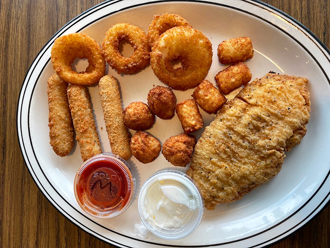 The indecisive diner's dream plate: onion rings, mozzarella sticks, and chicken—a fried trifecta that says "diet starts tomorrow" in the most delicious way. 