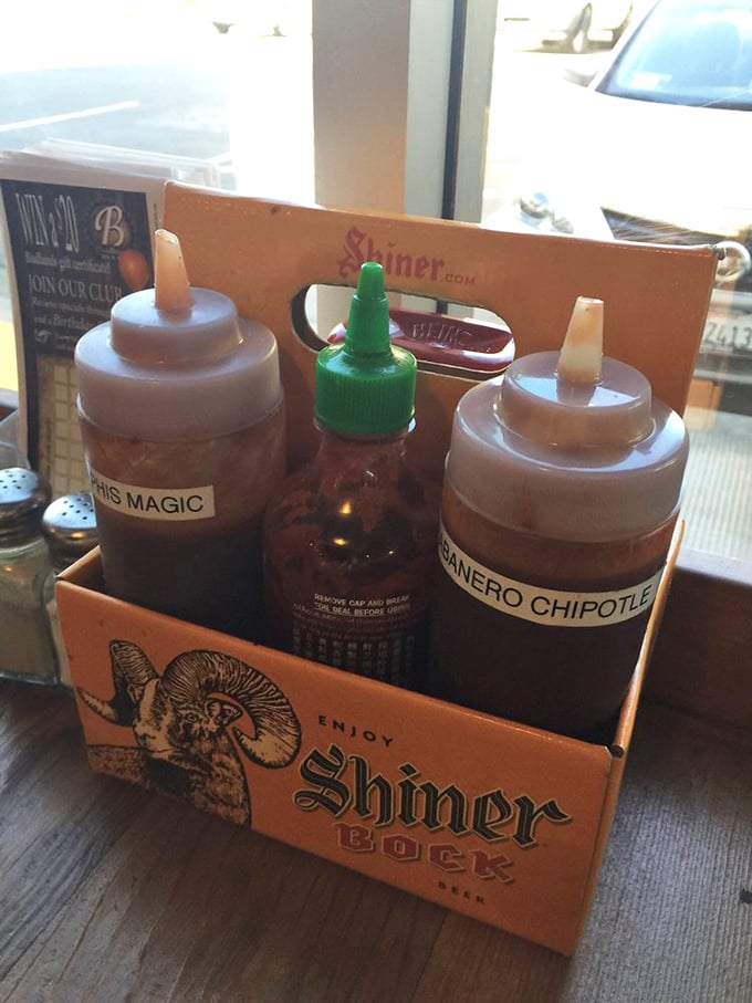 The sauce caddy stands ready like a flavor first-aid kit—because variety is the spice of barbecue life.