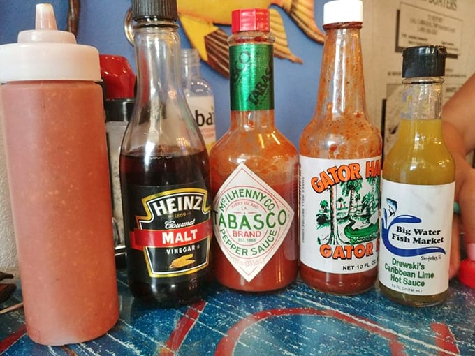 The condiment lineup—where culinary magic begins. From classic Tabasco to their house-made Drewski's Lime Hot Sauce, each bottle promises to elevate your seafood experience.
