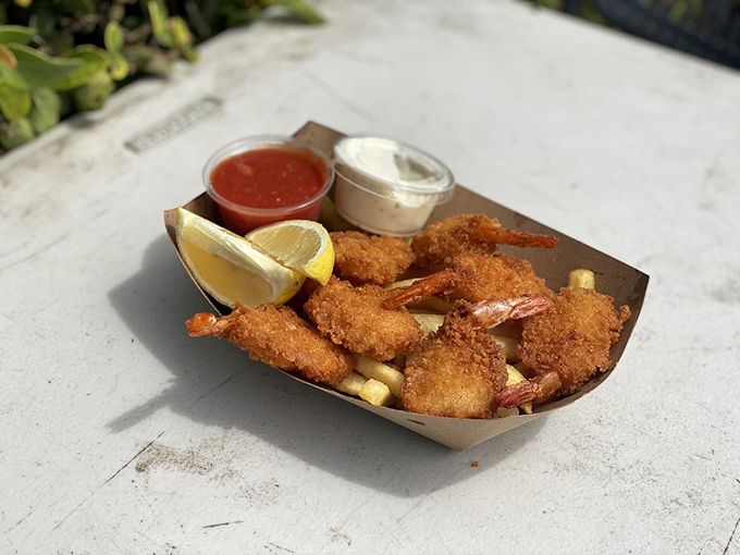 Golden-fried shrimp nestled beside crispy fries – proof that sometimes the simplest pleasures deliver the most profound satisfaction.