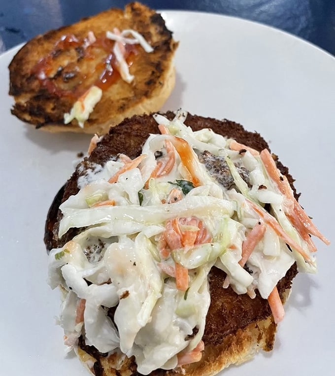 A sandwich that demands both hands and your full attention. That slaw adds the perfect crunch to complement the hearty bread beneath.