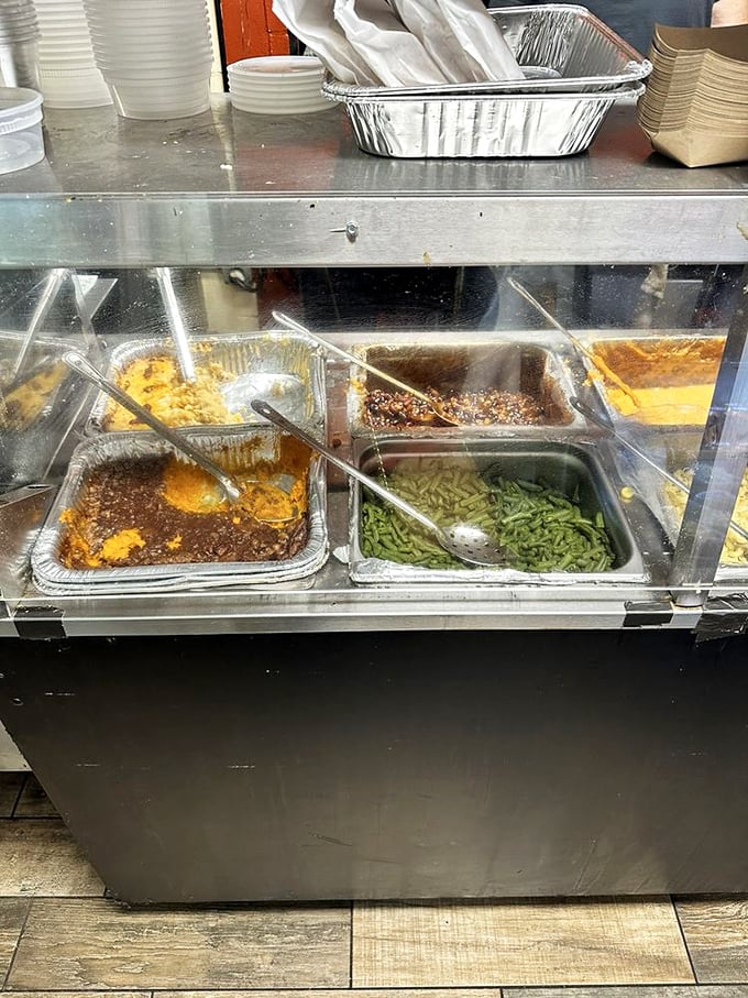 The side dish station—where vegetables earn their place at the barbecue table. Green beans, mac and cheese, and corn pudding wait patiently for their supporting roles.