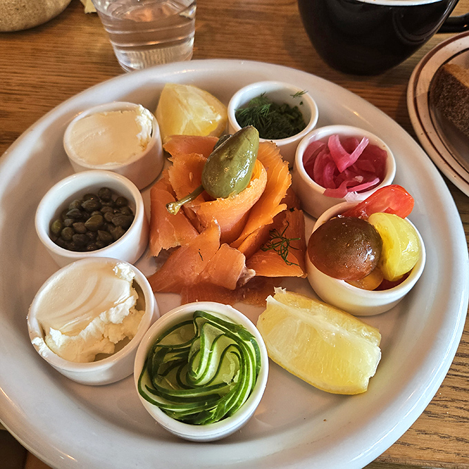 Not just a salmon platter – it's a color wheel of culinary delights where each tiny cup holds a perfect complement to the silky smoked fish.