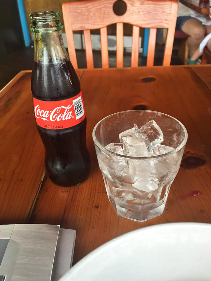 Even the classic Coca-Cola gets the proper Southern treatment—glass bottle, plenty of ice, and a wooden table that's seen thousands of good meals.