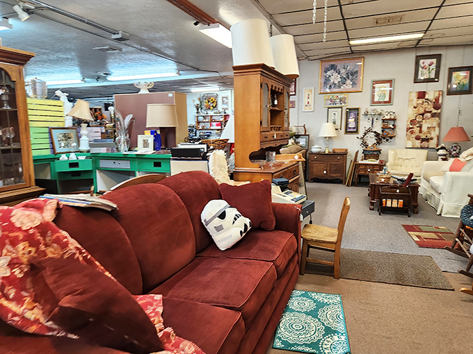 Cozy seating arrangements await new homes. That burgundy sofa has seen things—including a Stormtrooper mask ready for its next mission.
