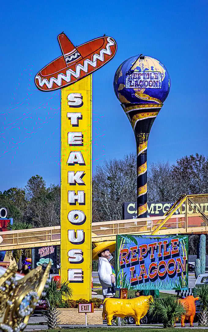 The "Steakhouse" sign towers over the landscape like a culinary lighthouse, beckoning hungry travelers with its sombrero-topped promise. 