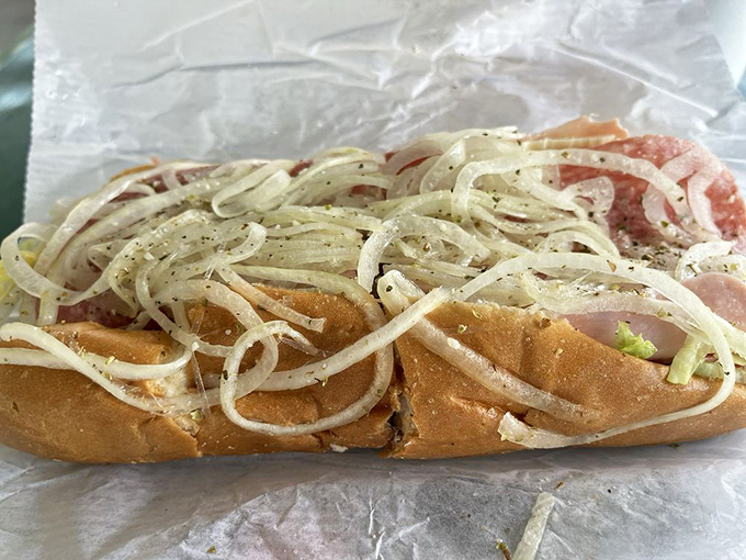 Layer upon glorious layer. This isn't just a sub—it's a carefully orchestrated symphony of meats, cheese, and fresh toppings.