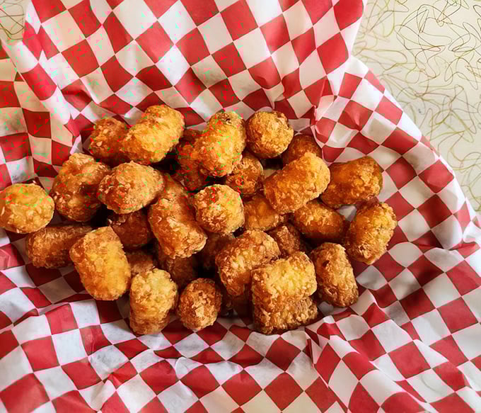 Golden-brown tater tots nestled in their checkered paper cradle—each one a crispy, potato-y time machine back to the best school lunch you never had.