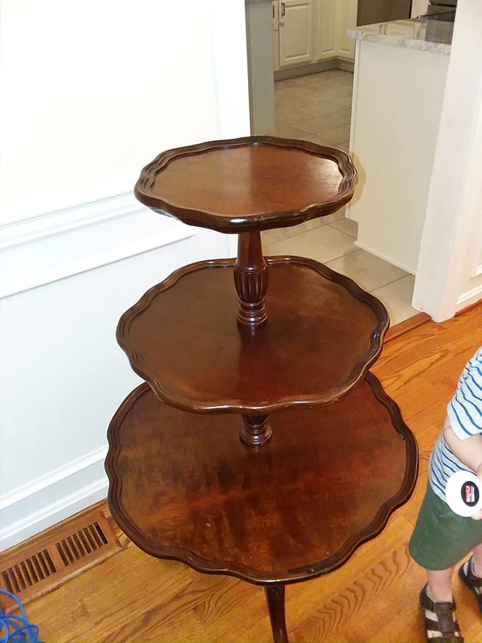 The three-tiered pie crust table isn't just furniture—it's functional sculpture. Perfect for displaying your collection of… well, anything really.