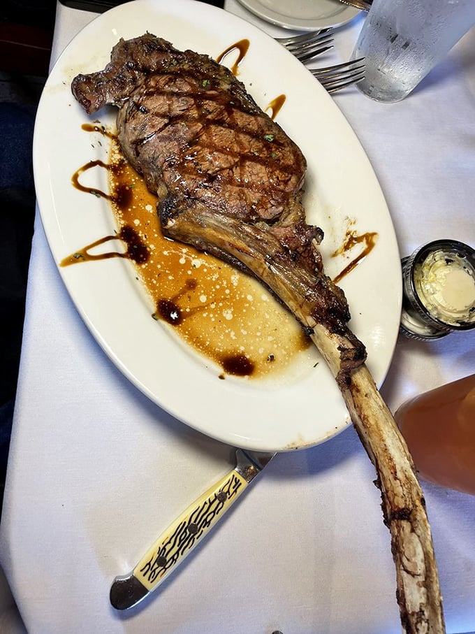 The tomahawk steak arrives like a prehistoric declaration of carnivorous intent. That bone isn't just for show – it's nature's built-in handle for your protein.