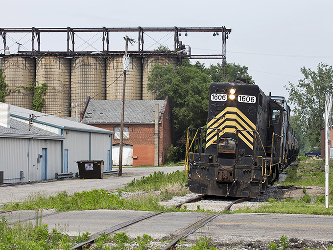 The local train represents Napoleon's industrial heritage, chugging along tracks that connect this small town to the wider economic world.