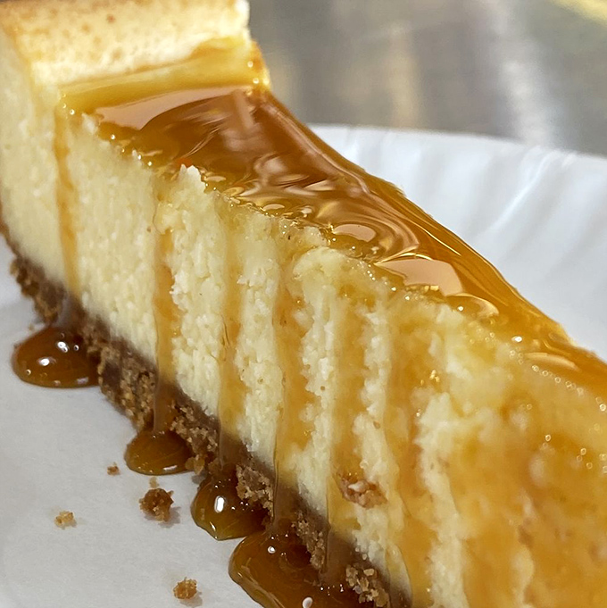 Caramel cascading down vanilla cheesecake like a sweet waterfall. This isn't just dessert—it's a religious experience on a plate.