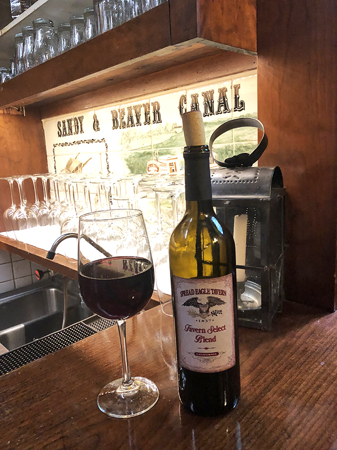 Their house wine sits beside a historical canal illustration—both transport you somewhere wonderful. One sip and suddenly Ohio feels remarkably like Tuscany.