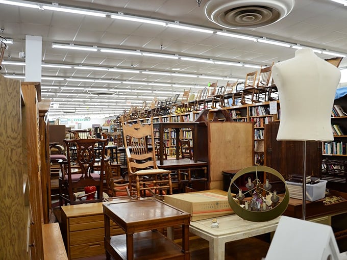 Books to the left, chairs overhead, and enough wooden treasures to make you consider renting a U-Haul instead of bringing your sedan.