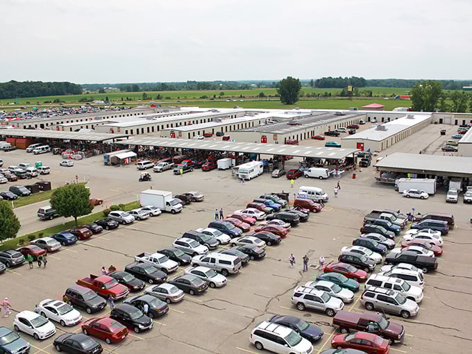 An aerial view of weekend warriors on the hunt for bargains! Cars fill the lot as shoppers fill their bags.