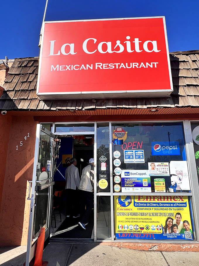 La Casita's bright red sign stands out against Flagstaff's blue skies. A pop of color that promises spicy delights inside!