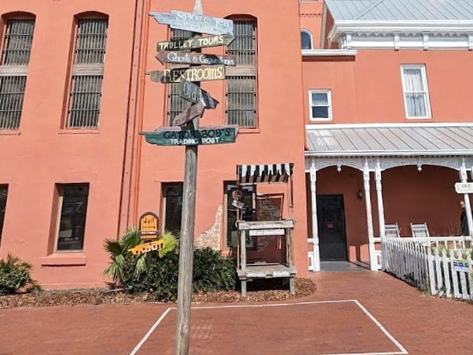 Wooden signs pointing in every direction – a perfect metaphor for the chaotic history housed in this old jail.