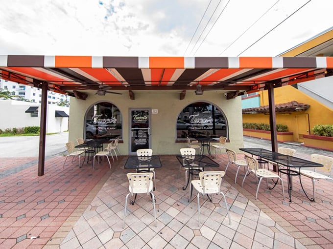 Tucci's striped awning creates the perfect pizza patio atmosphere. That brick courtyard practically begs you to linger over one more slice.