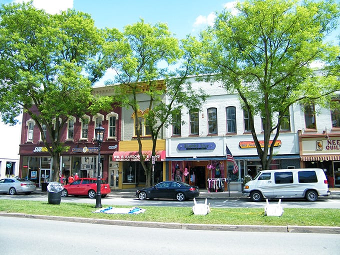 The vibrant storefronts of Wellsboro pop against the blue sky like a painter's palette. Window shopping here isn't a pastime – it's an art form!