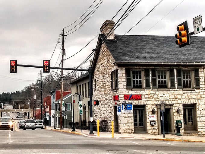 Bedford's main street feels frozen in time, where historic stone buildings host modern businesses and traffic lights seem almost anachronistic against the 19th-century backdrop.