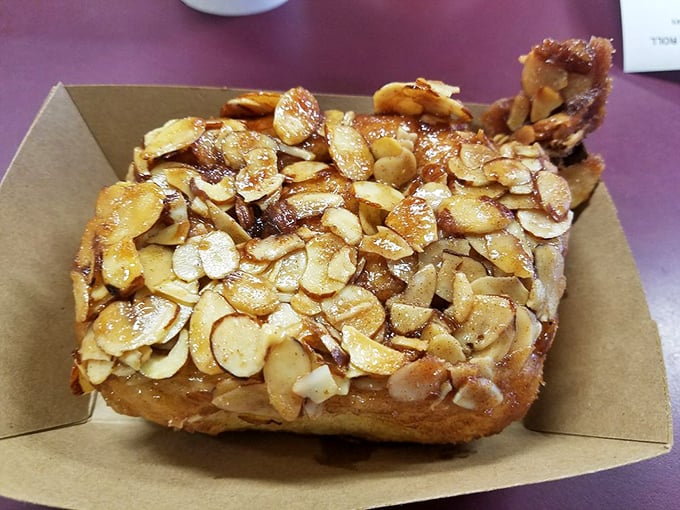 Sliced almonds cascading over golden dough like nature's confetti. This almond-topped beauty offers a delightful crunch with every heavenly bite.