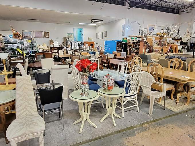 An elegant white bistro set holds court among sofas and side tables, like a Parisian café that somehow landed in a Florida thrift store.