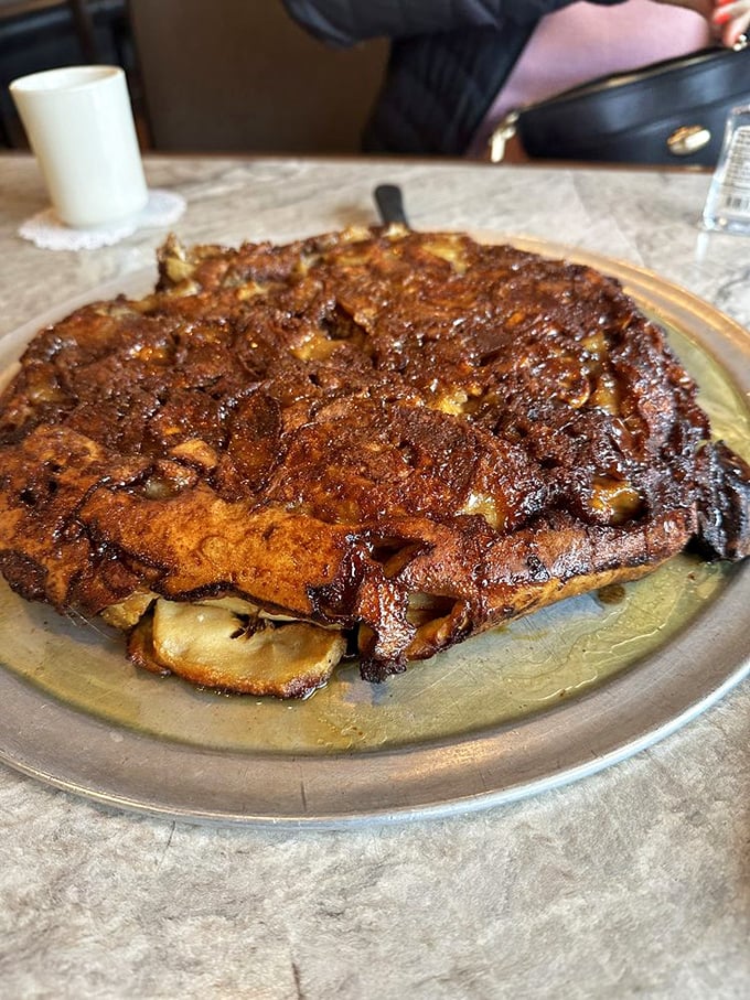 The apple pancake – a golden-brown monument to morning indulgence that makes ordinary flapjacks look like they're not even trying.