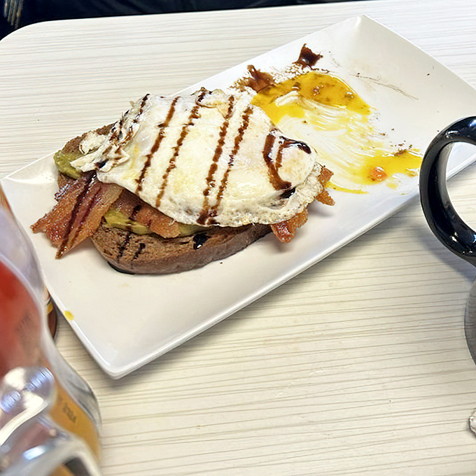 Breakfast architecture at its finest—a perfectly cooked egg crowning a throne of toast, ready for its Instagram moment.