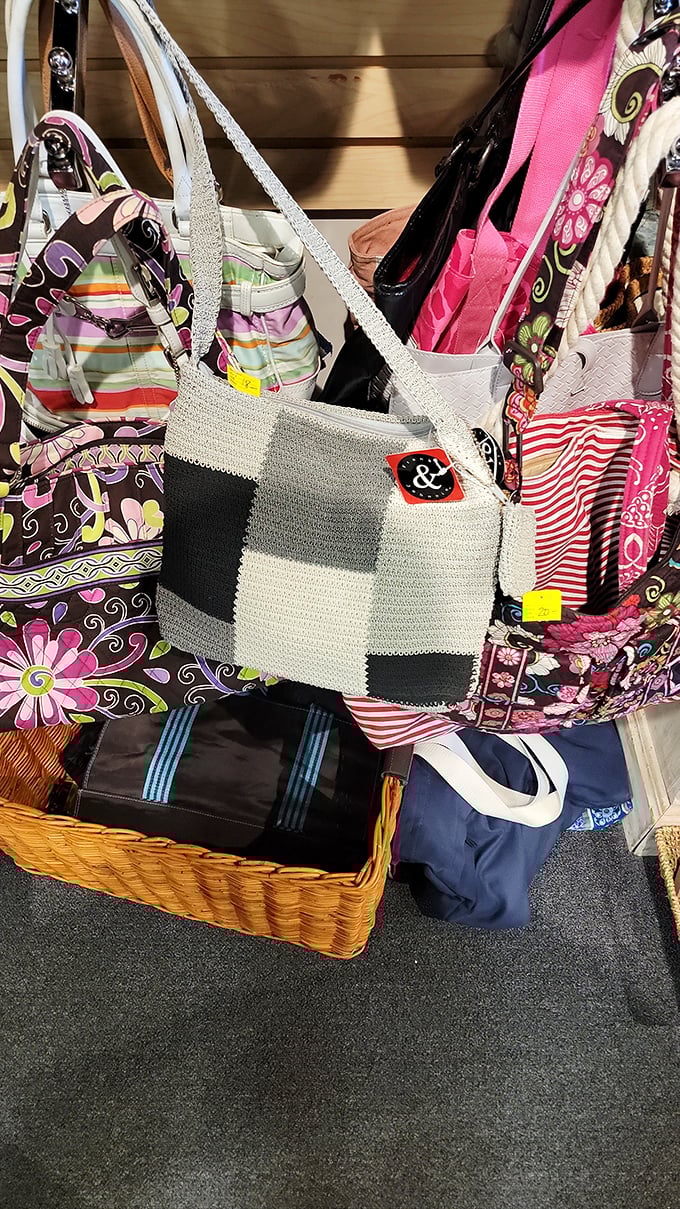 A colorful congregation of handbags hangs in hopeful anticipation—each one ready for a second chance at accessorizing someone's life.