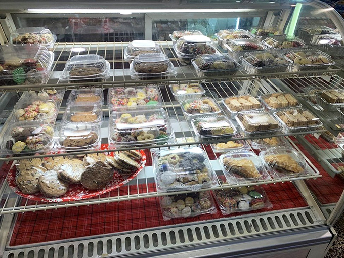 The dessert case—where willpower goes to die. Each plastic container holds a sweet promise that "just coffee" was never really the plan.